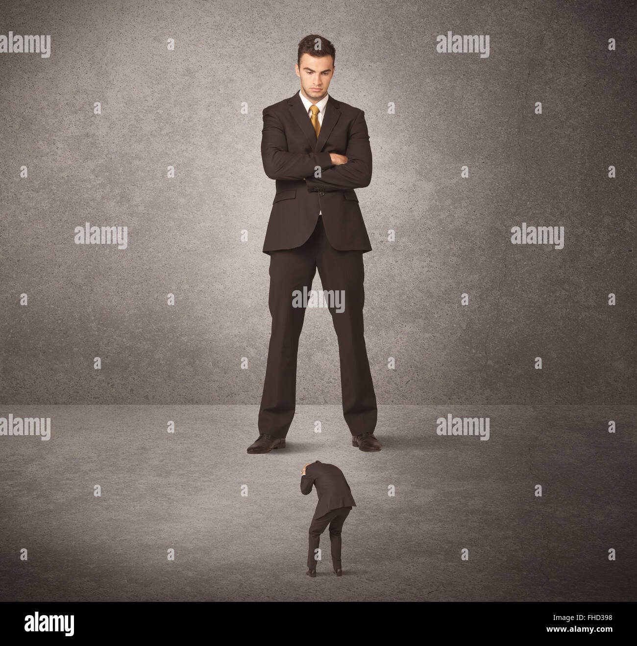 Big business man looking at small worker Stock Photo - Alamy