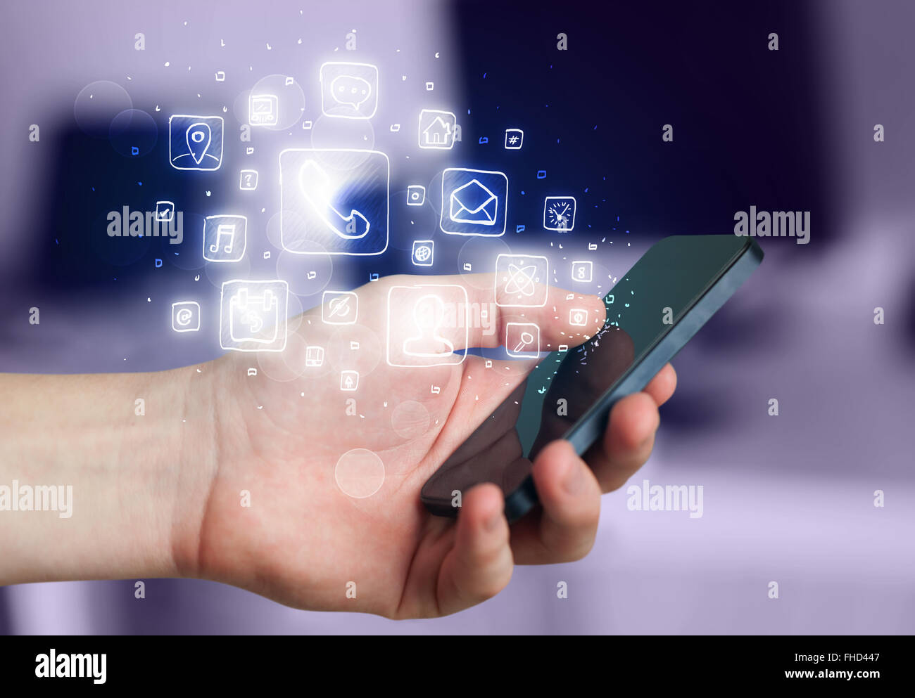 Hand holding smartphone with mobile app icons Stock Photo - Alamy