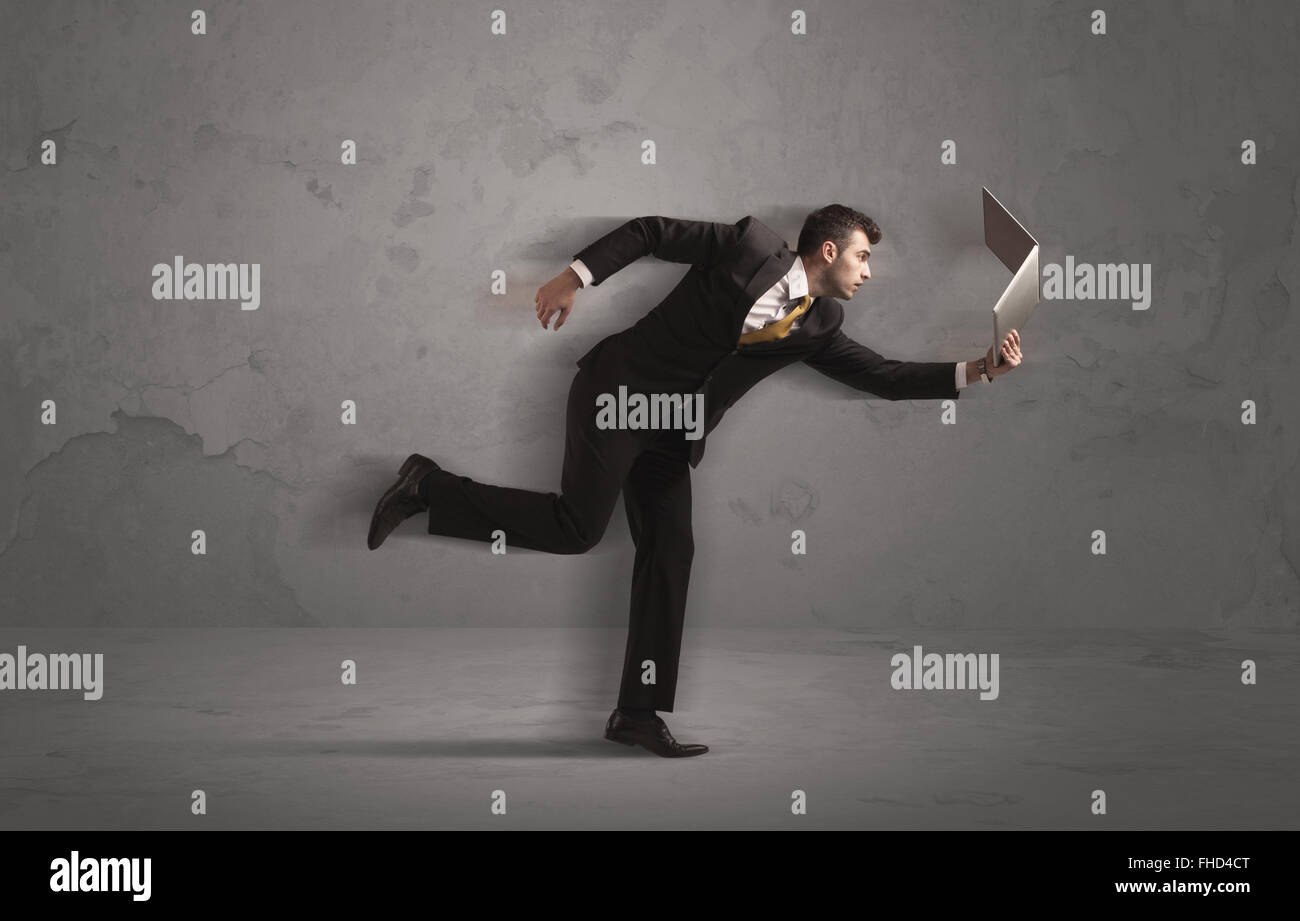 Running businessman with device in hand Stock Photo - Alamy
