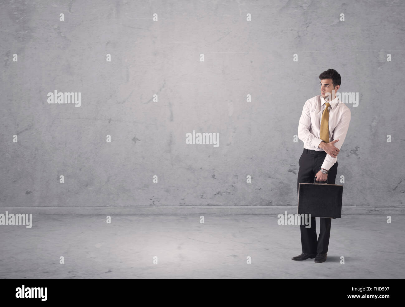 Young businessman standing confused Stock Photo - Alamy