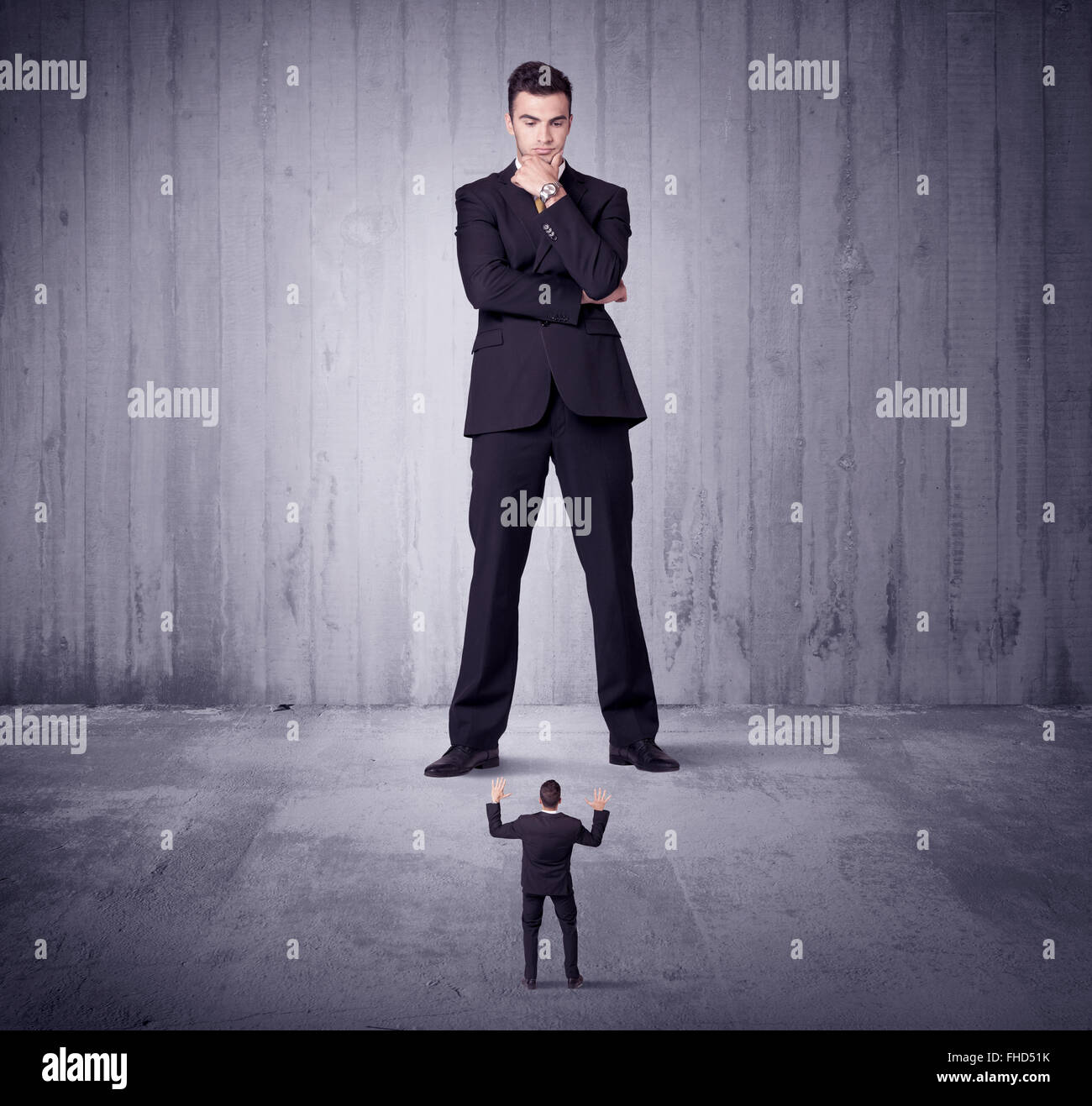Huge boss lokking at small business man Stock Photo - Alamy