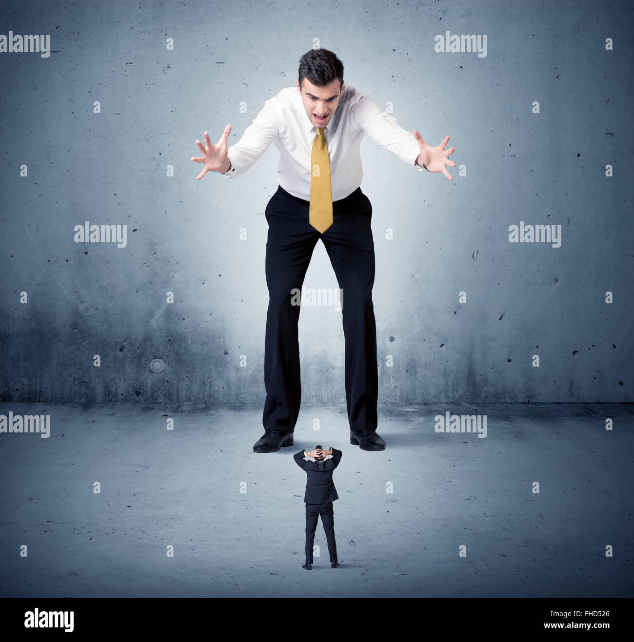 Angry huge business man lokking at small guy Stock Photo - Alamy