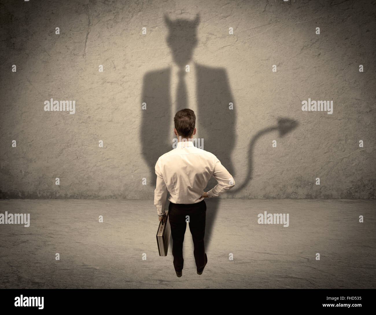 Salesman facing his own devil shadow Stock Photo - Alamy