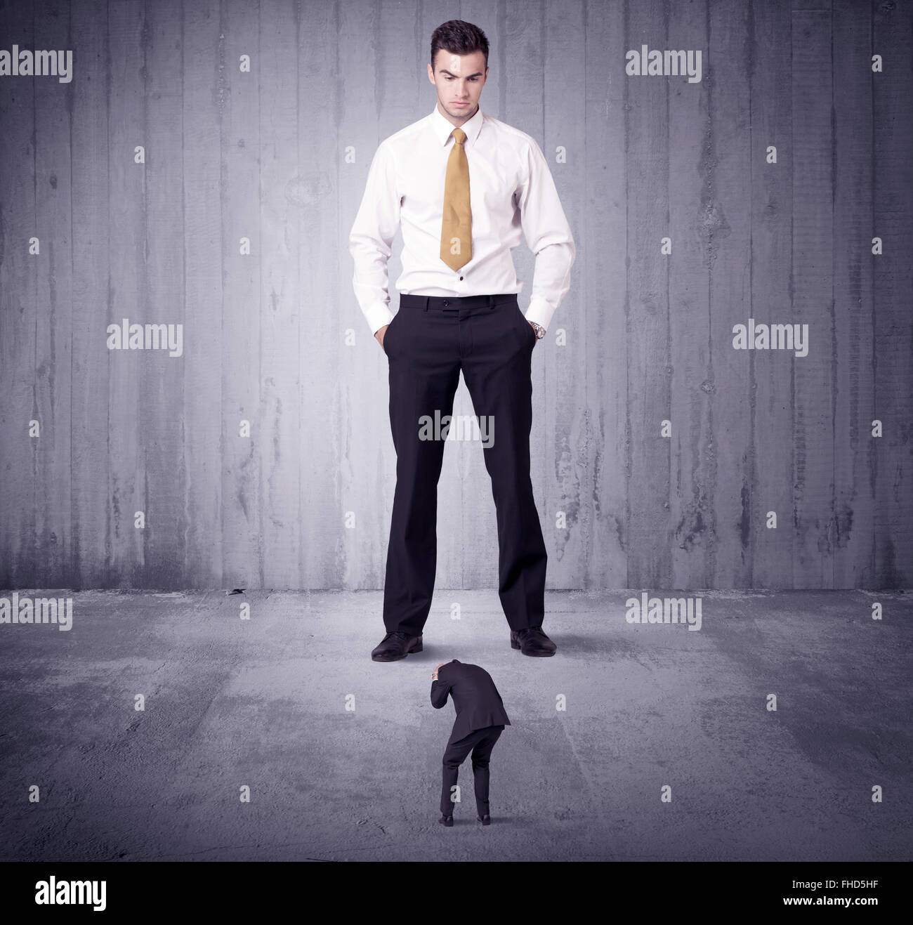 Huge boss lokking at small business man Stock Photo - Alamy