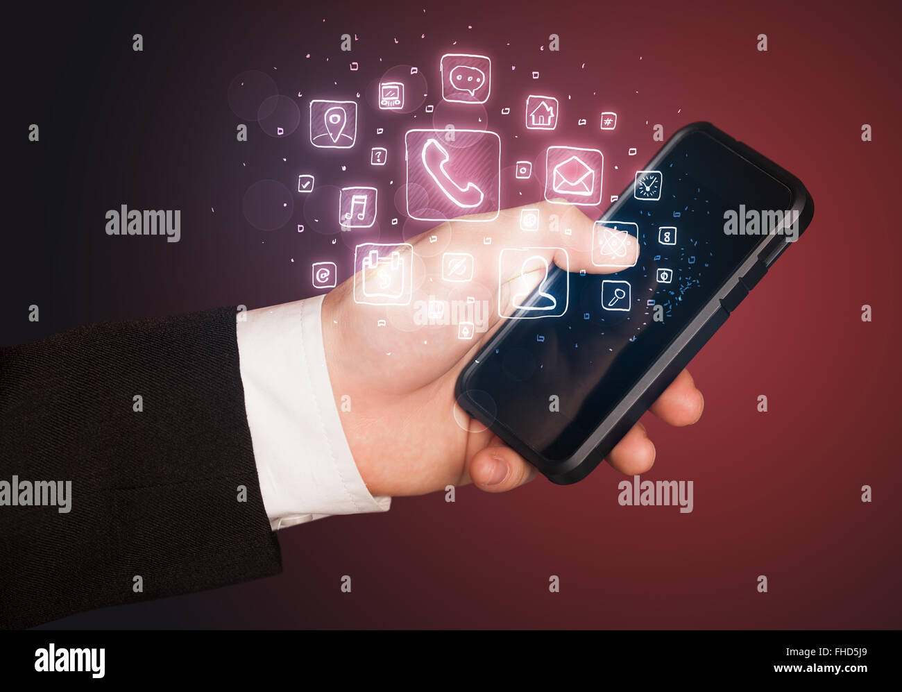 Hand holding smartphone with mobile app icons Stock Photo - Alamy