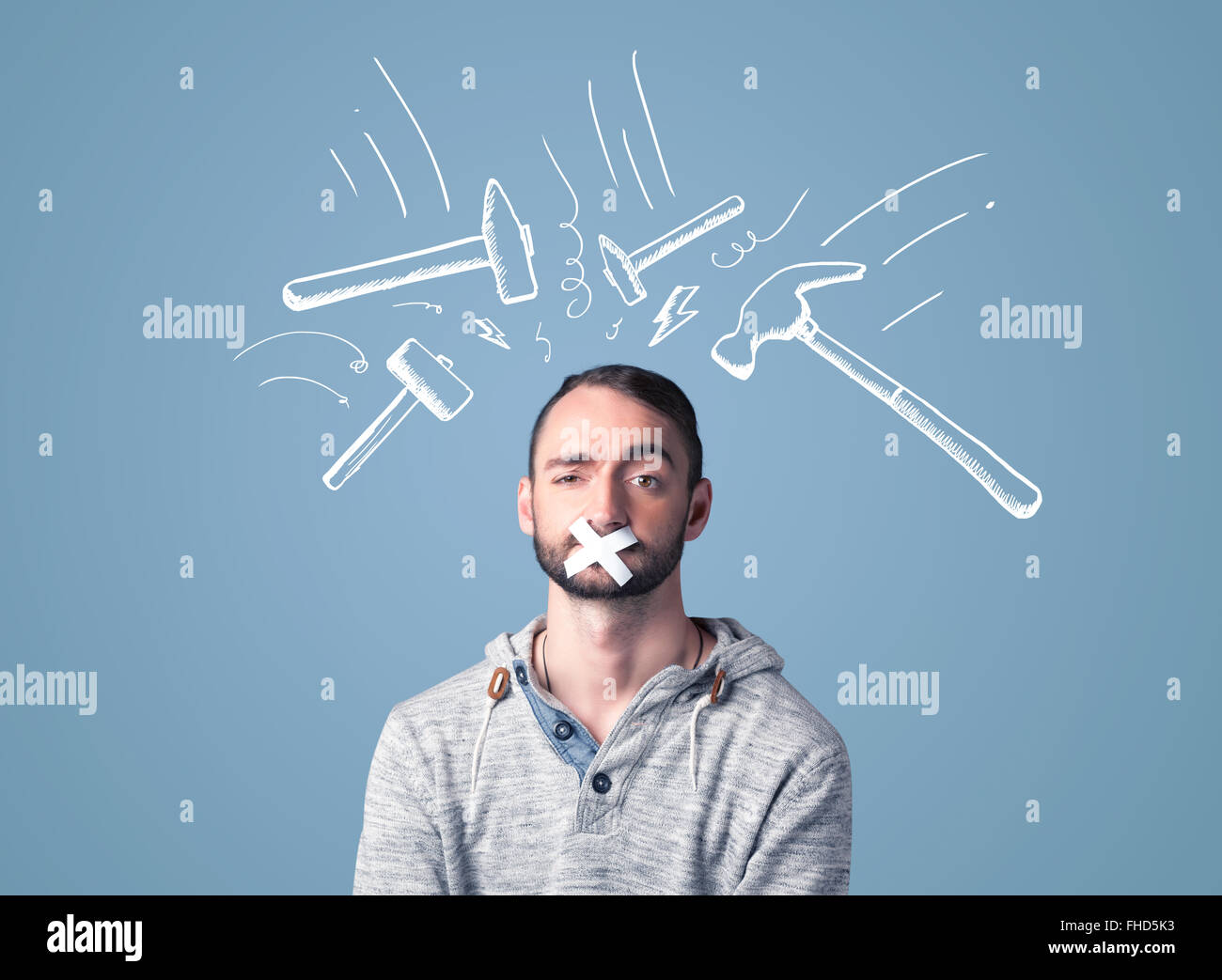 Young man with glued mouth and beating hammer marks Stock Photo - Alamy