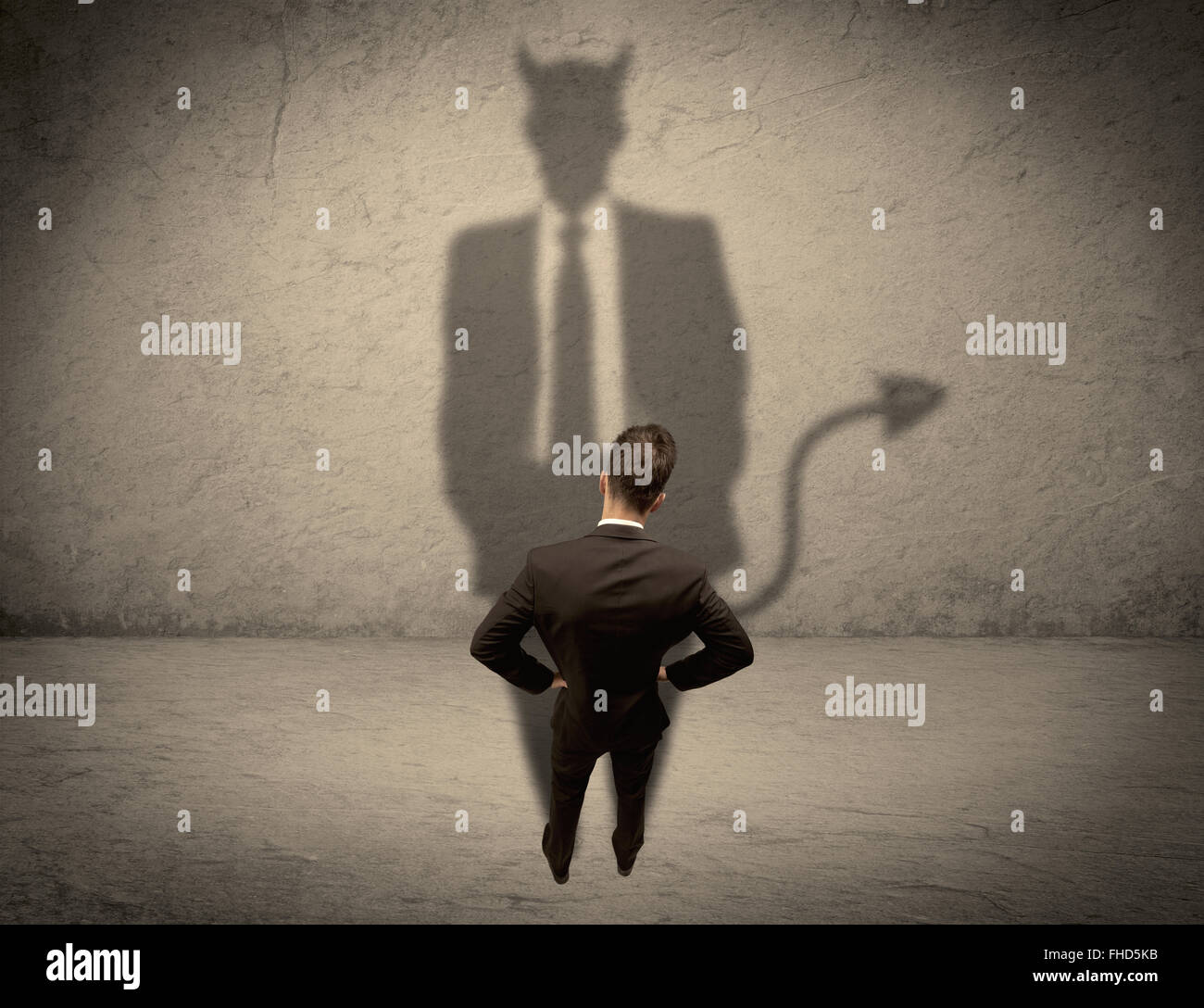 Salesman facing his own devil shadow Stock Photo - Alamy