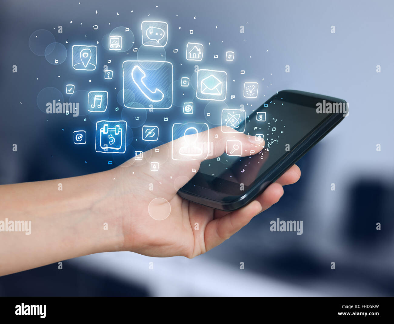 Hand holding smartphone with mobile app icons Stock Photo - Alamy