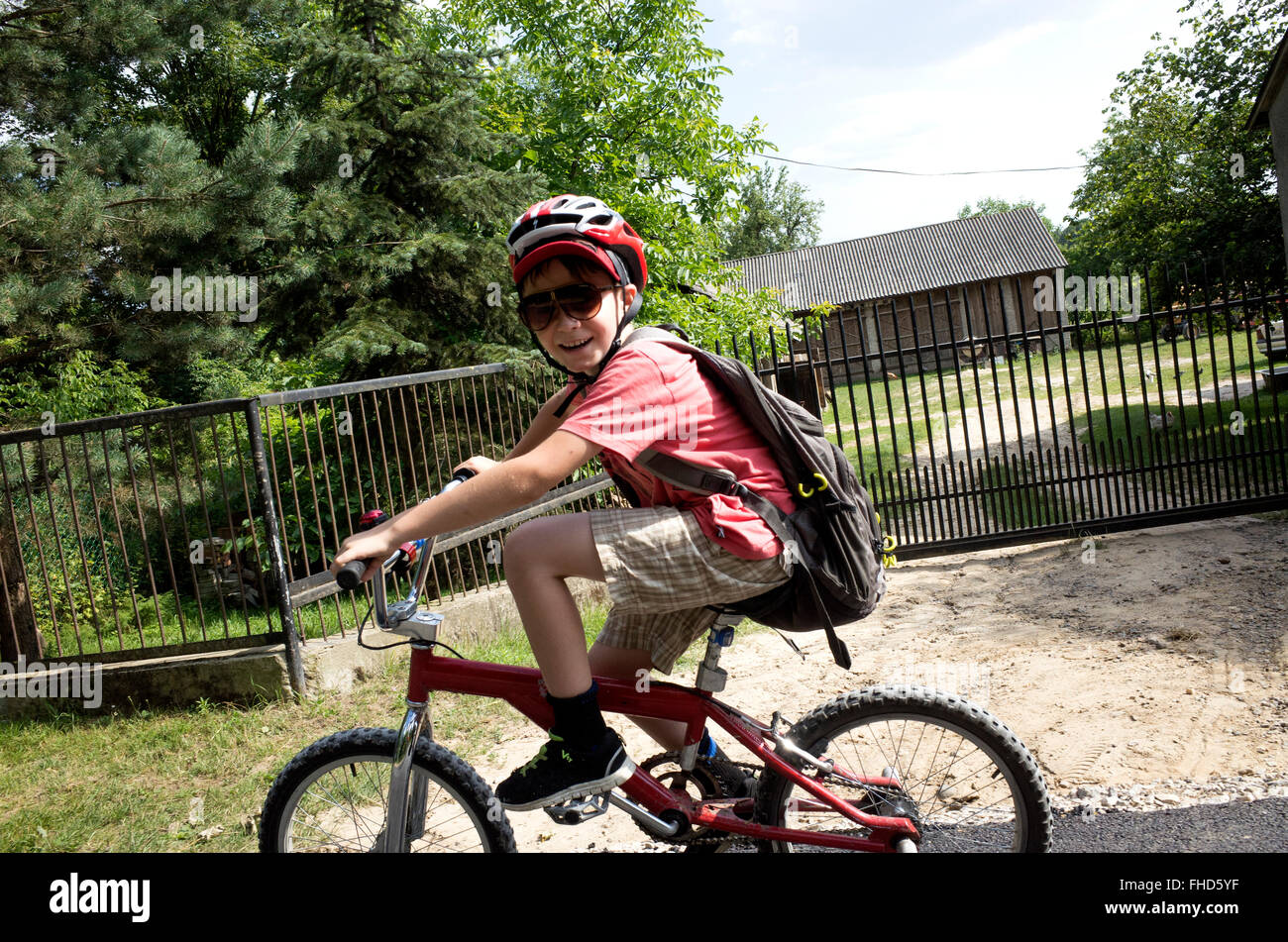 Happy young bicycler wearing helmet riding bike. Rzeczyca Central ...