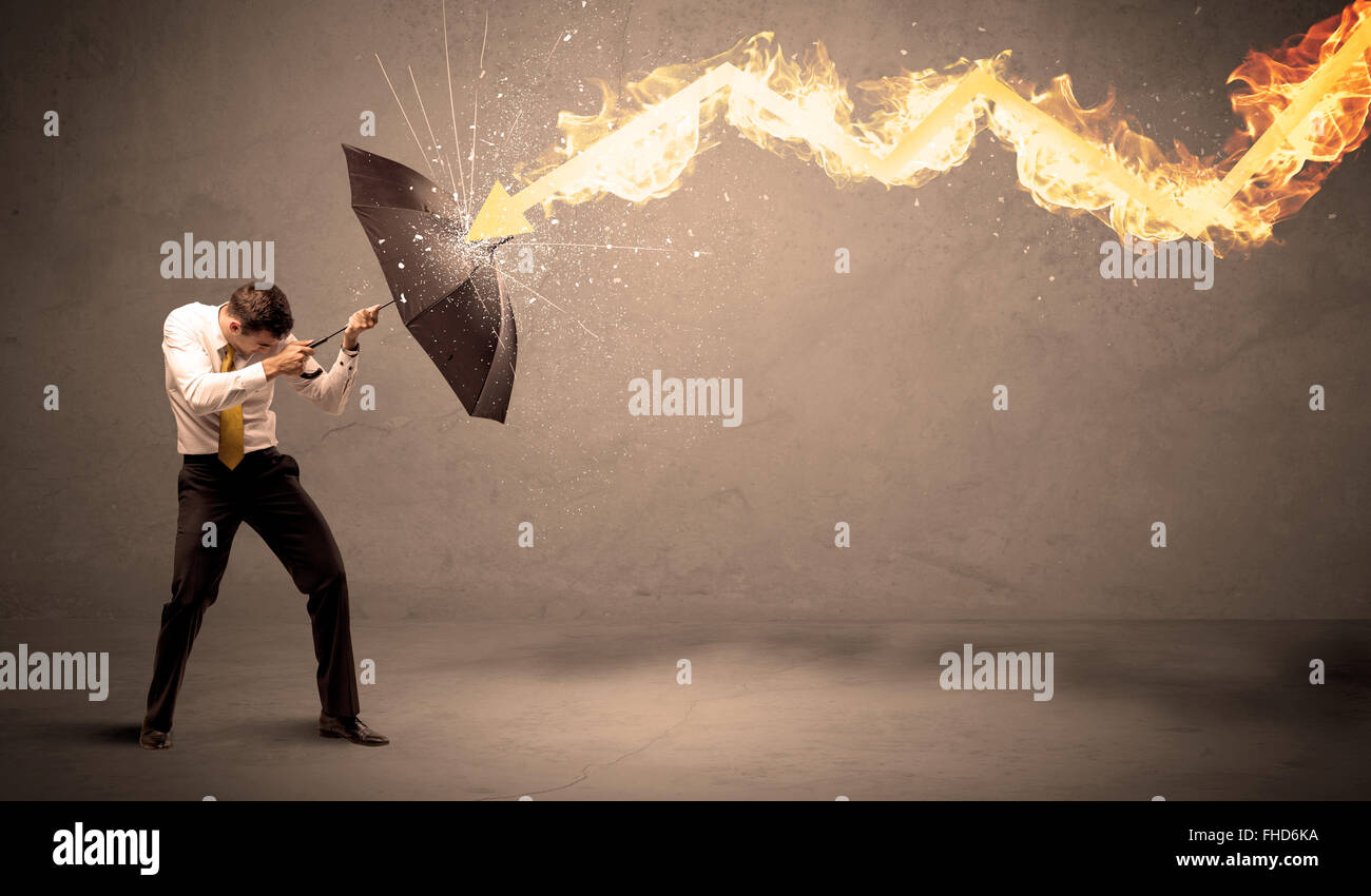 Business man defending himself from a fire arrow with an umbrella Stock ...