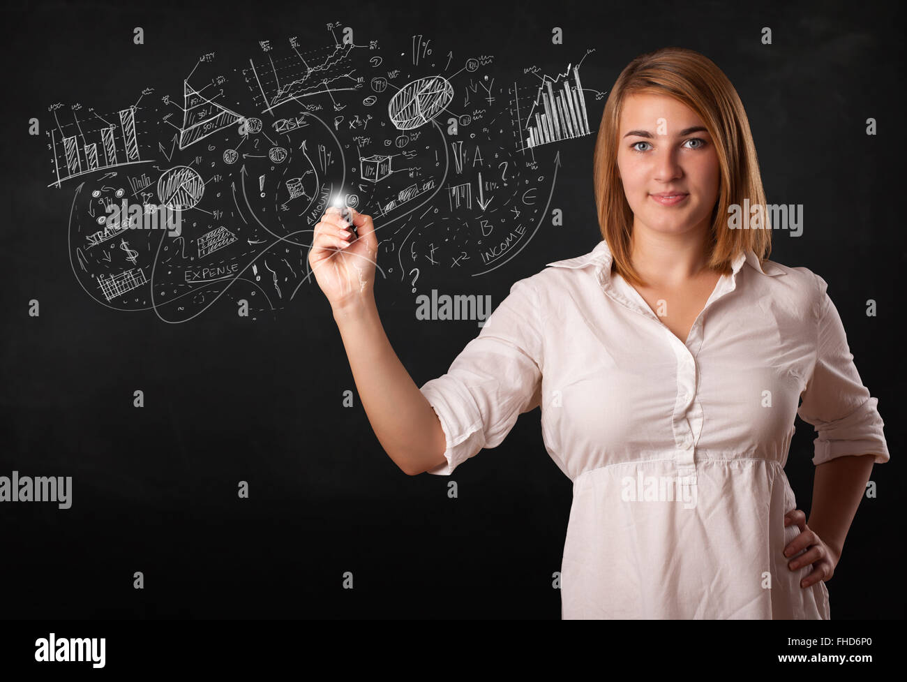 Pretty girl sketching graphs and diagrams on wall Stock Photo - Alamy
