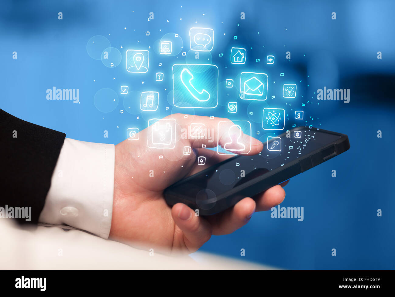 Hand holding smartphone with mobile app icons Stock Photo - Alamy