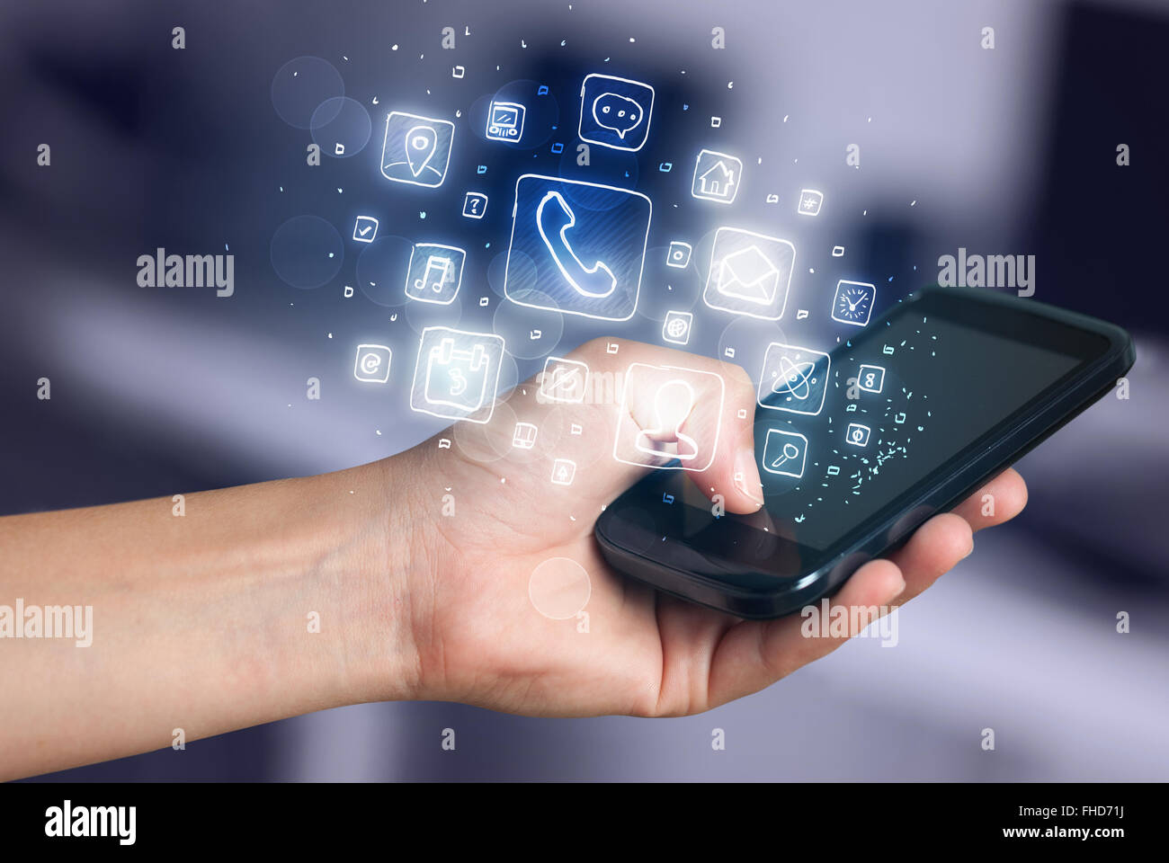 Hand holding smartphone with mobile app icons Stock Photo - Alamy