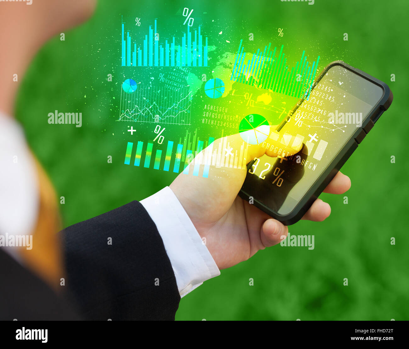 Hand holding smartphone with business diagrams Stock Photo - Alamy