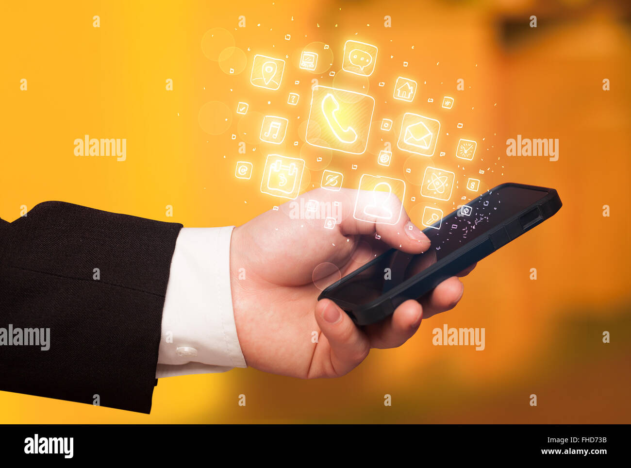 Hand holding smartphone with mobile app icons Stock Photo - Alamy