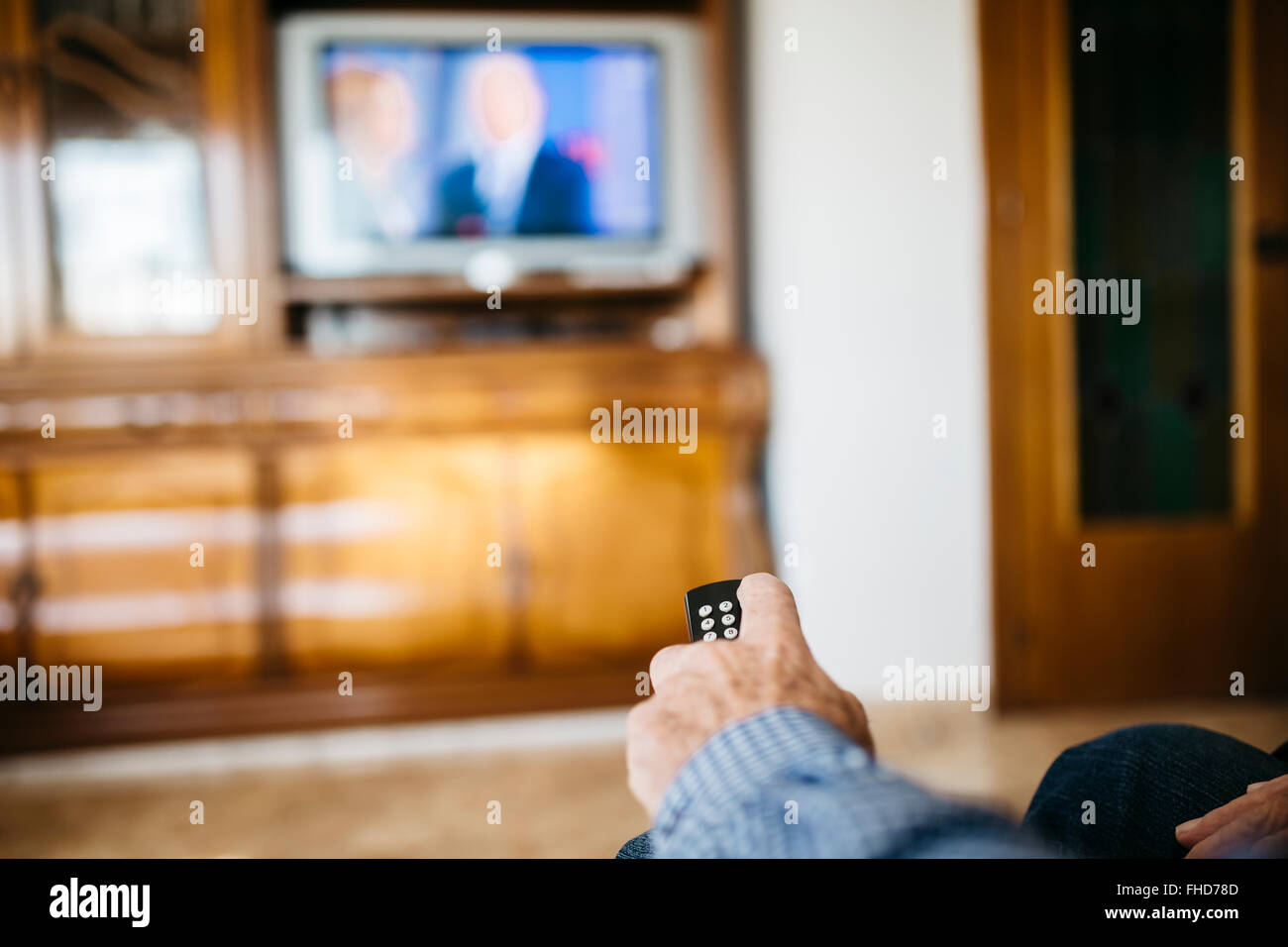Hand of senior man holding remote control, close-up Stock Photo - Alamy