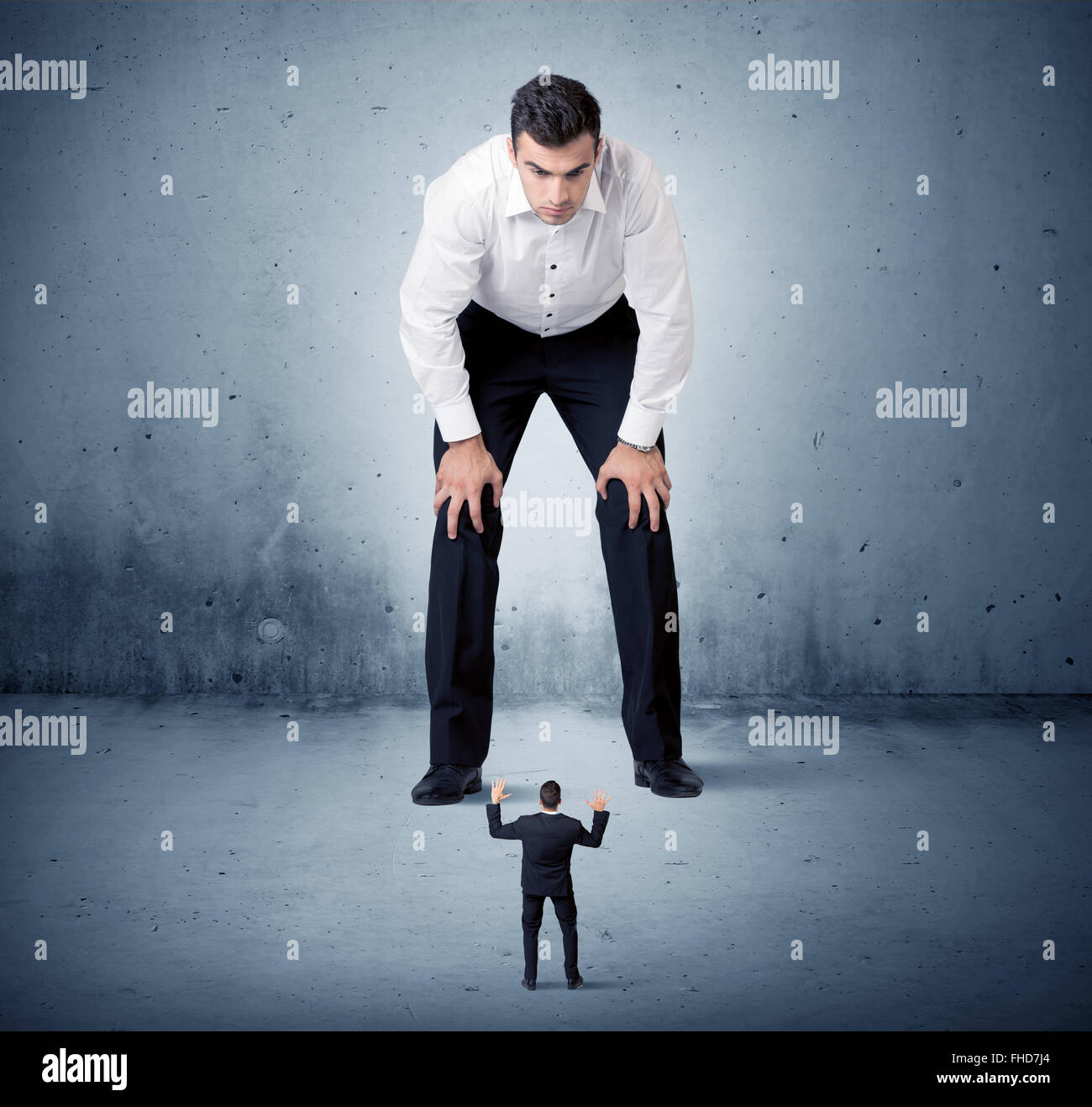 Angry huge business man lokking at small guy Stock Photo - Alamy