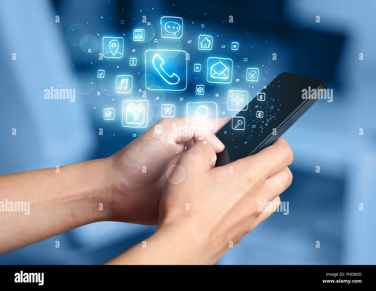Hand holding smartphone with mobile app icons Stock Photo - Alamy