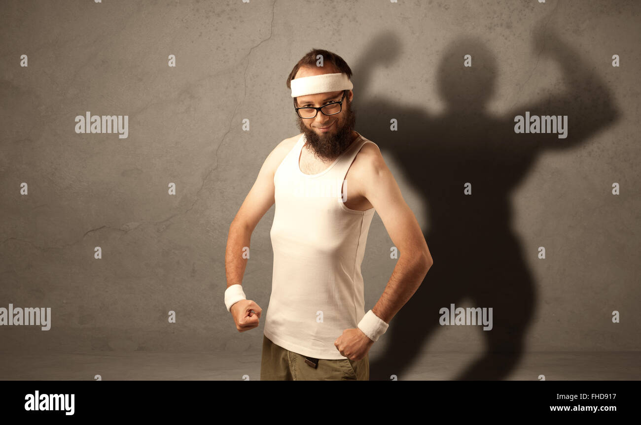 Skinny man with musculous shadow Stock Photo - Alamy