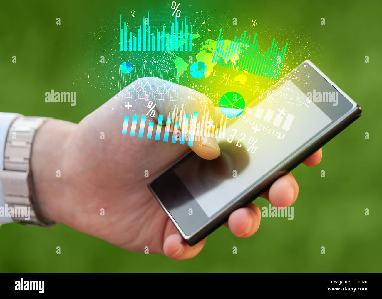 Hand holding smartphone with business diagrams Stock Photo - Alamy