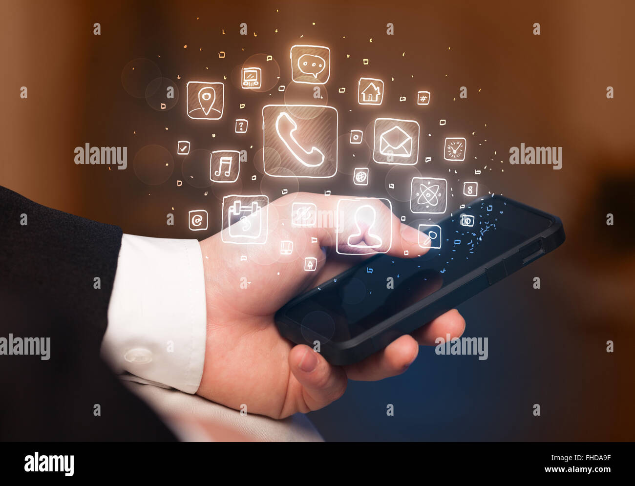 Hand holding smartphone with mobile app icons Stock Photo - Alamy