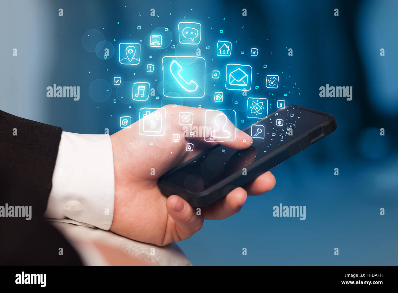 Hand holding smartphone with mobile app icons Stock Photo - Alamy