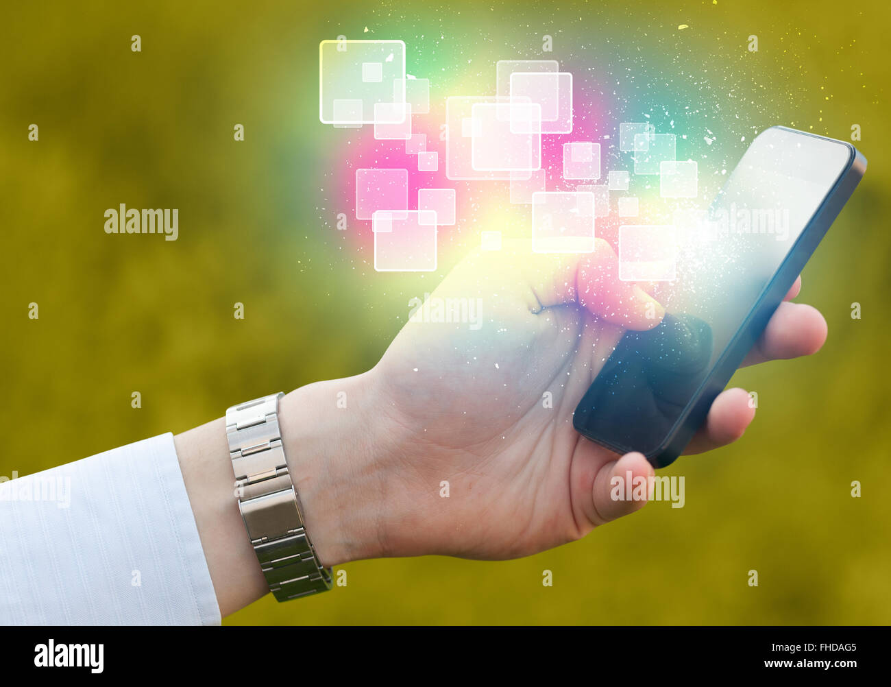 Hand holding smart phone with abstract glowing squares Stock Photo - Alamy