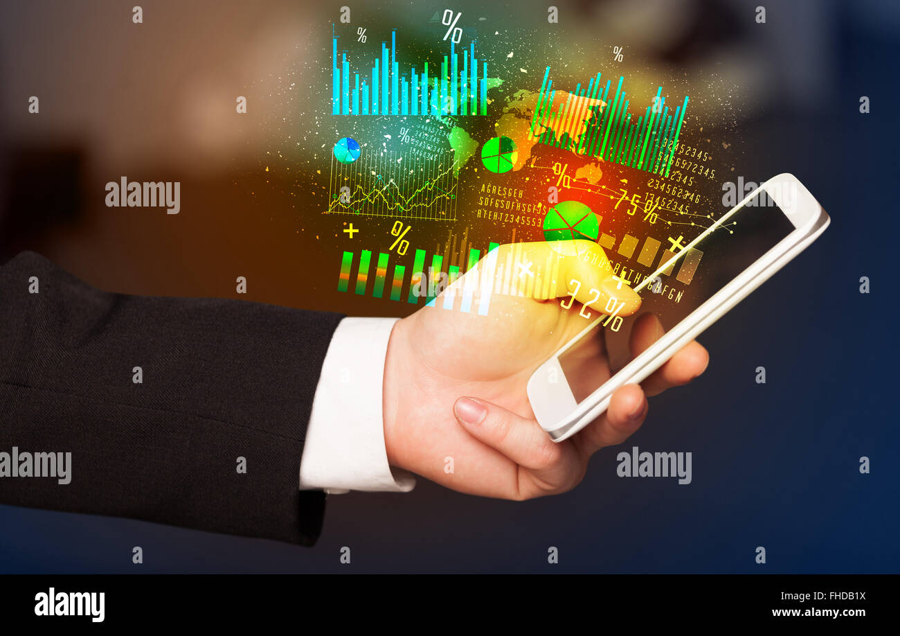Hand holding smartphone with business diagrams Stock Photo - Alamy