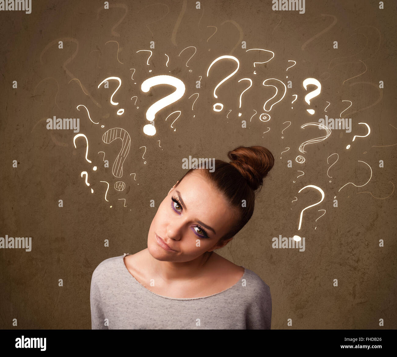 girl with question mark symbols around her head Stock Photo - Alamy