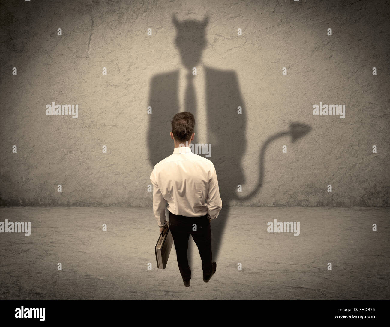 Salesman facing his own devil shadow Stock Photo - Alamy