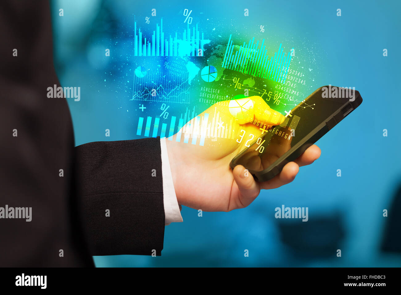 Hand holding smartphone with business diagrams Stock Photo - Alamy