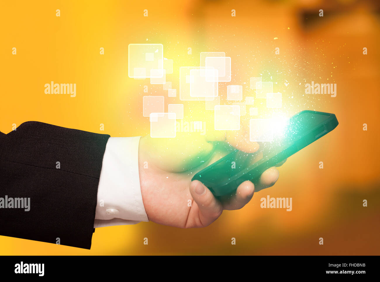 Hand holding smart phone with abstract glowing squares Stock Photo - Alamy
