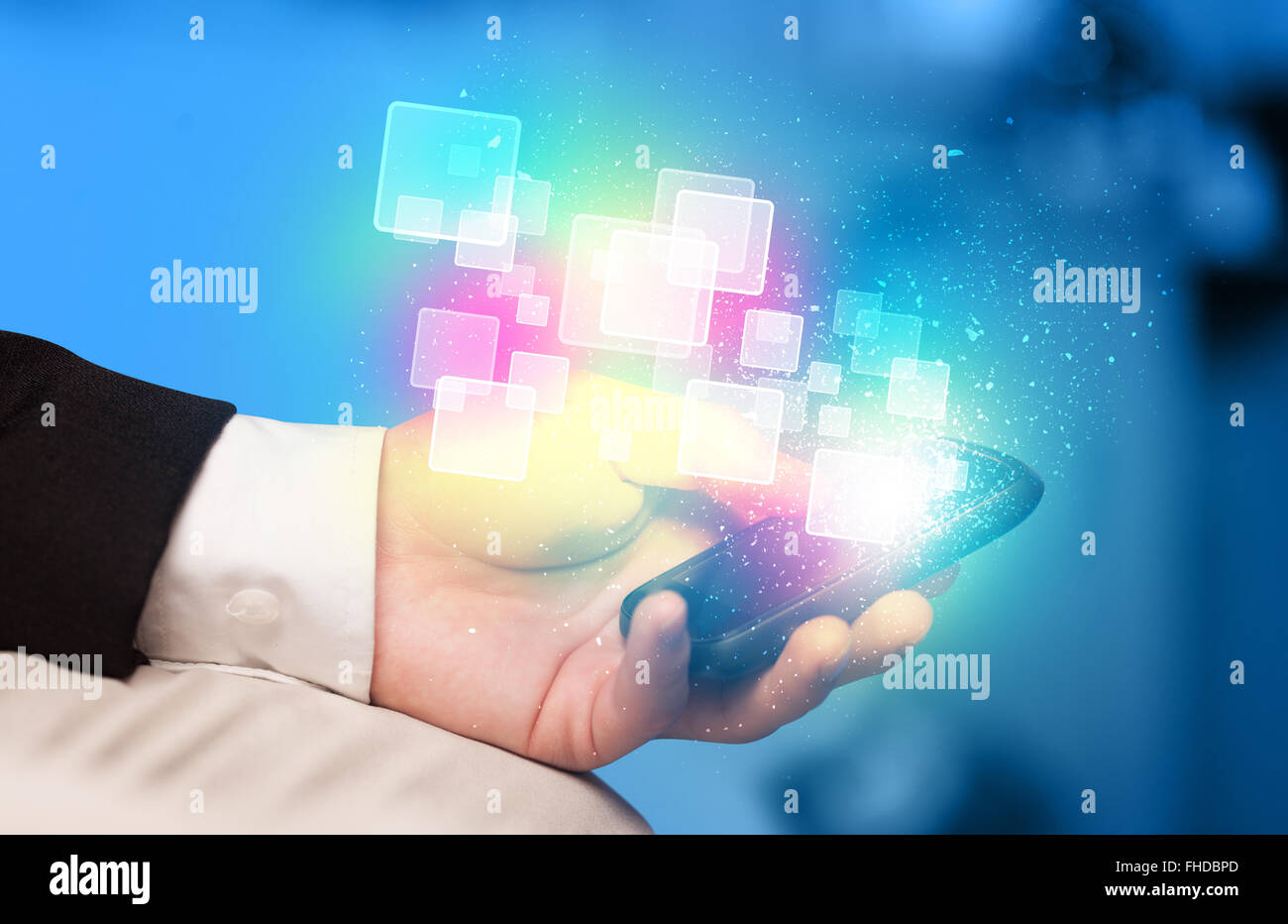 Hand holding smart phone with abstract glowing squares Stock Photo - Alamy