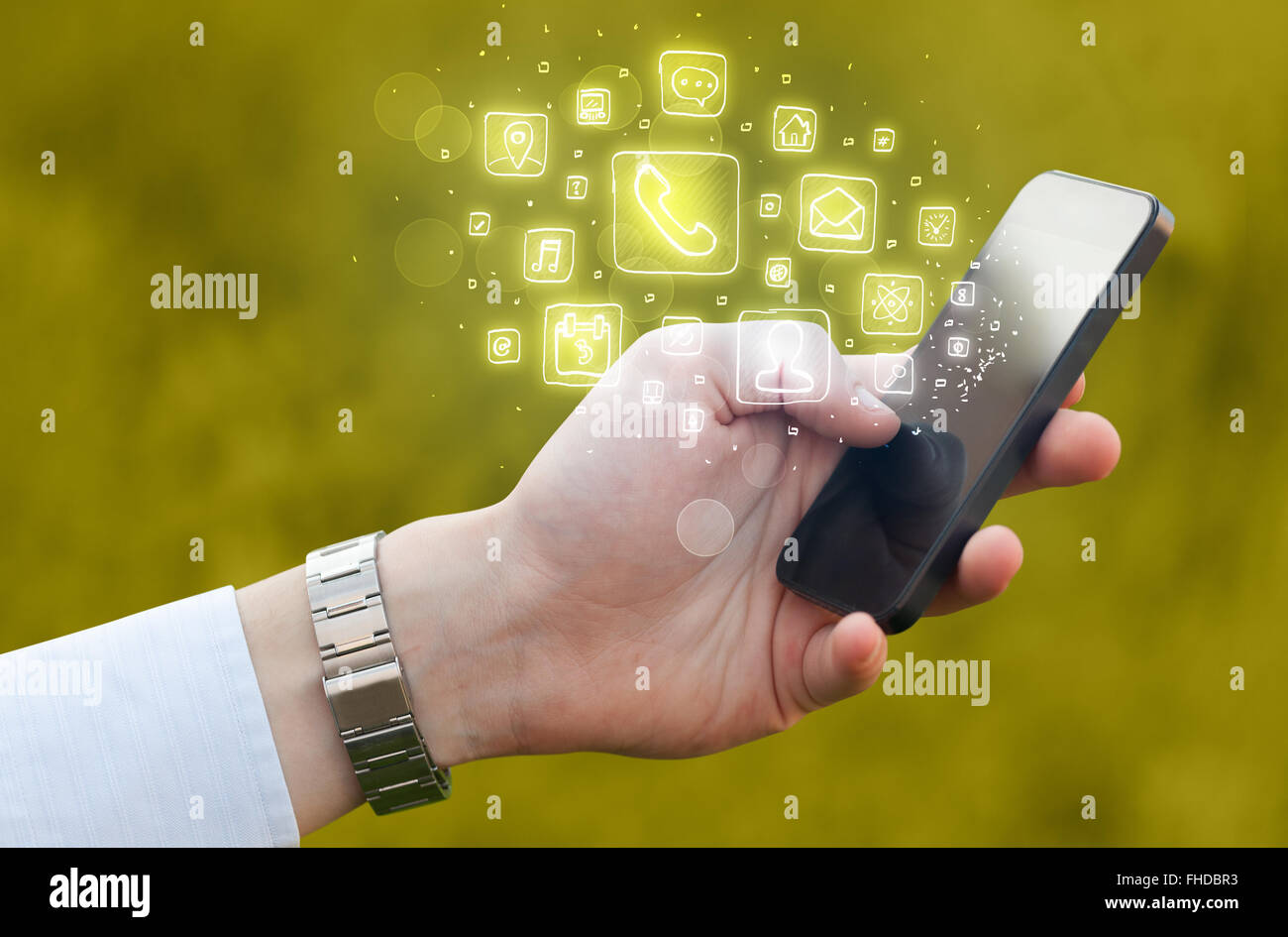 Hand holding smartphone with mobile app icons Stock Photo - Alamy