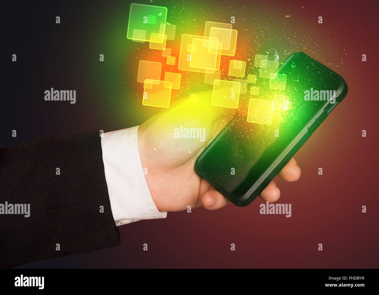 Hand holding smart phone with abstract glowing squares Stock Photo - Alamy