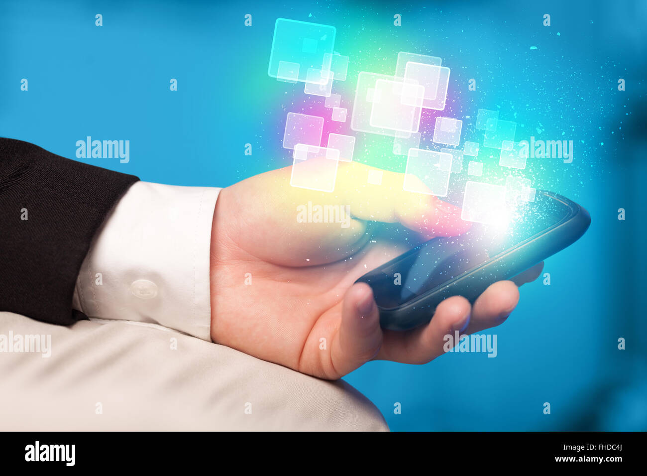 Hand holding smart phone with abstract glowing squares Stock Photo - Alamy
