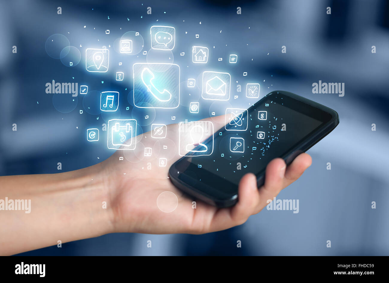 Hand holding smartphone with mobile app icons Stock Photo - Alamy