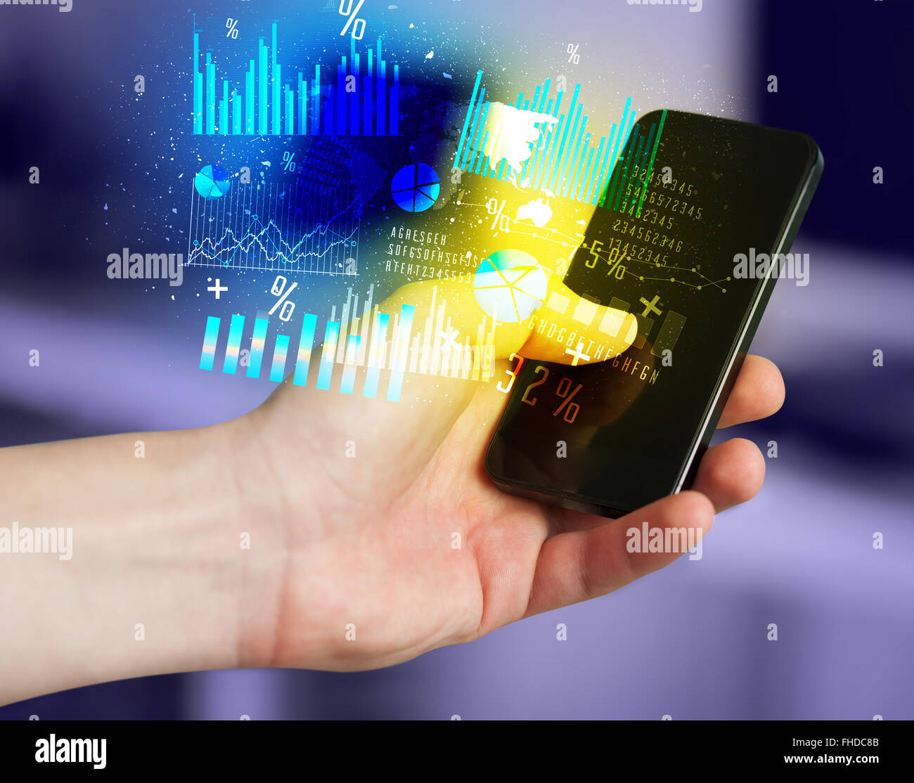 Hand holding smartphone with business diagrams Stock Photo - Alamy