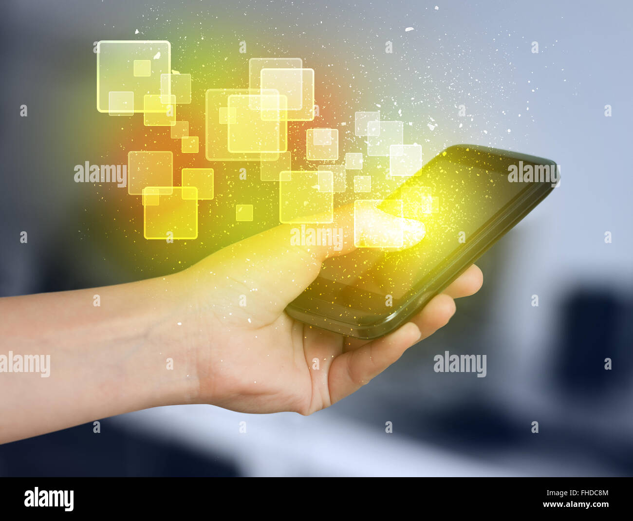 Hand holding smart phone with abstract glowing squares Stock Photo - Alamy
