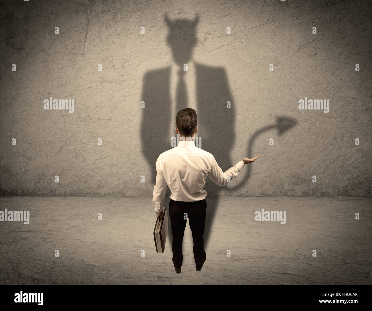 Salesman facing his own devil shadow Stock Photo - Alamy