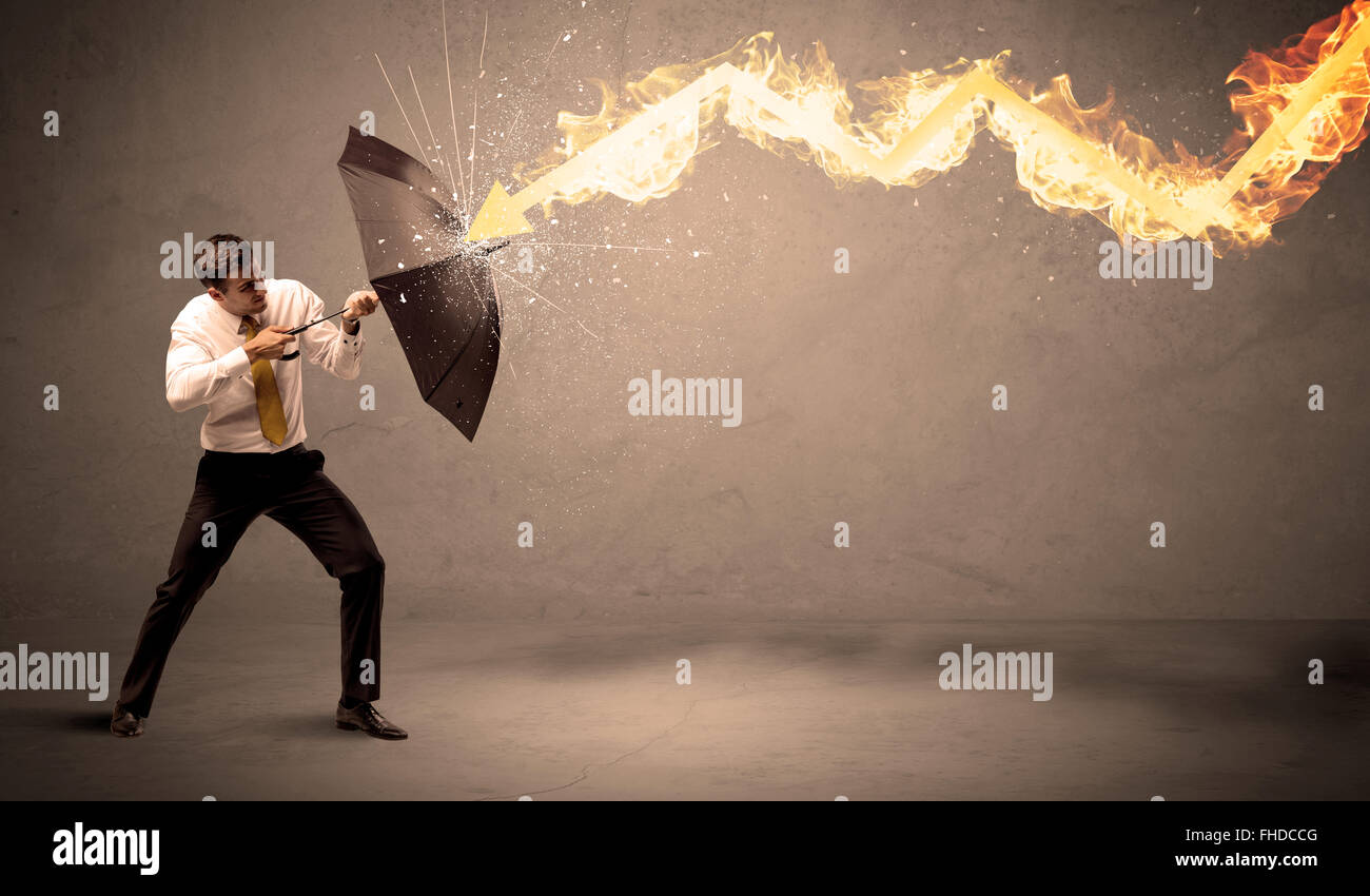 Business man defending himself from a fire arrow with an umbrella Stock ...