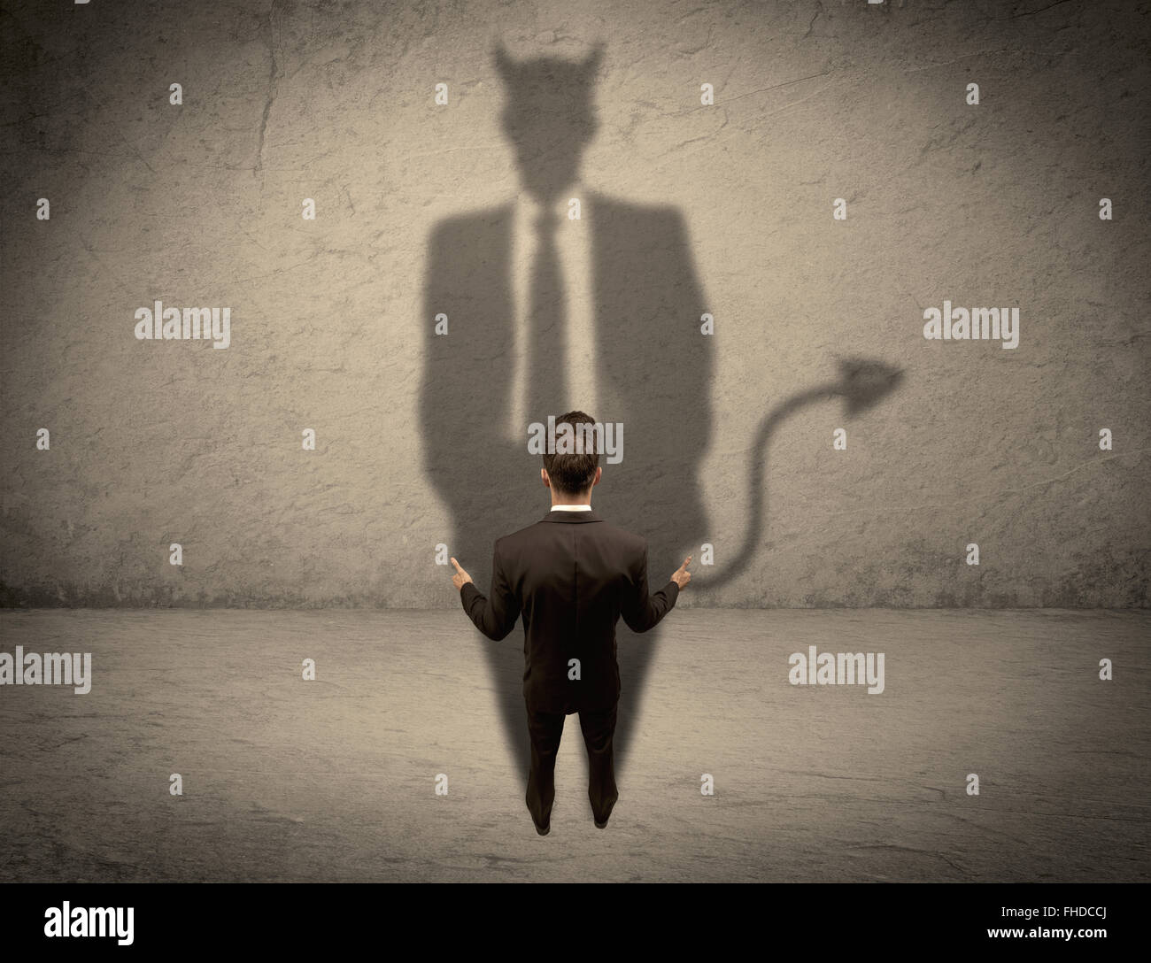 Salesman facing his own devil shadow Stock Photo - Alamy