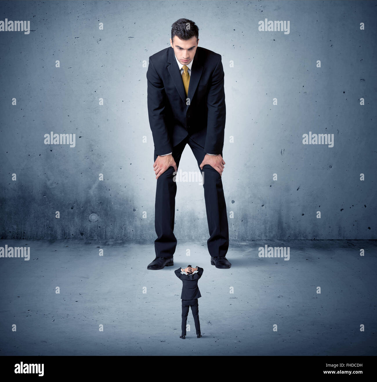 Angry huge business man lokking at small guy Stock Photo - Alamy