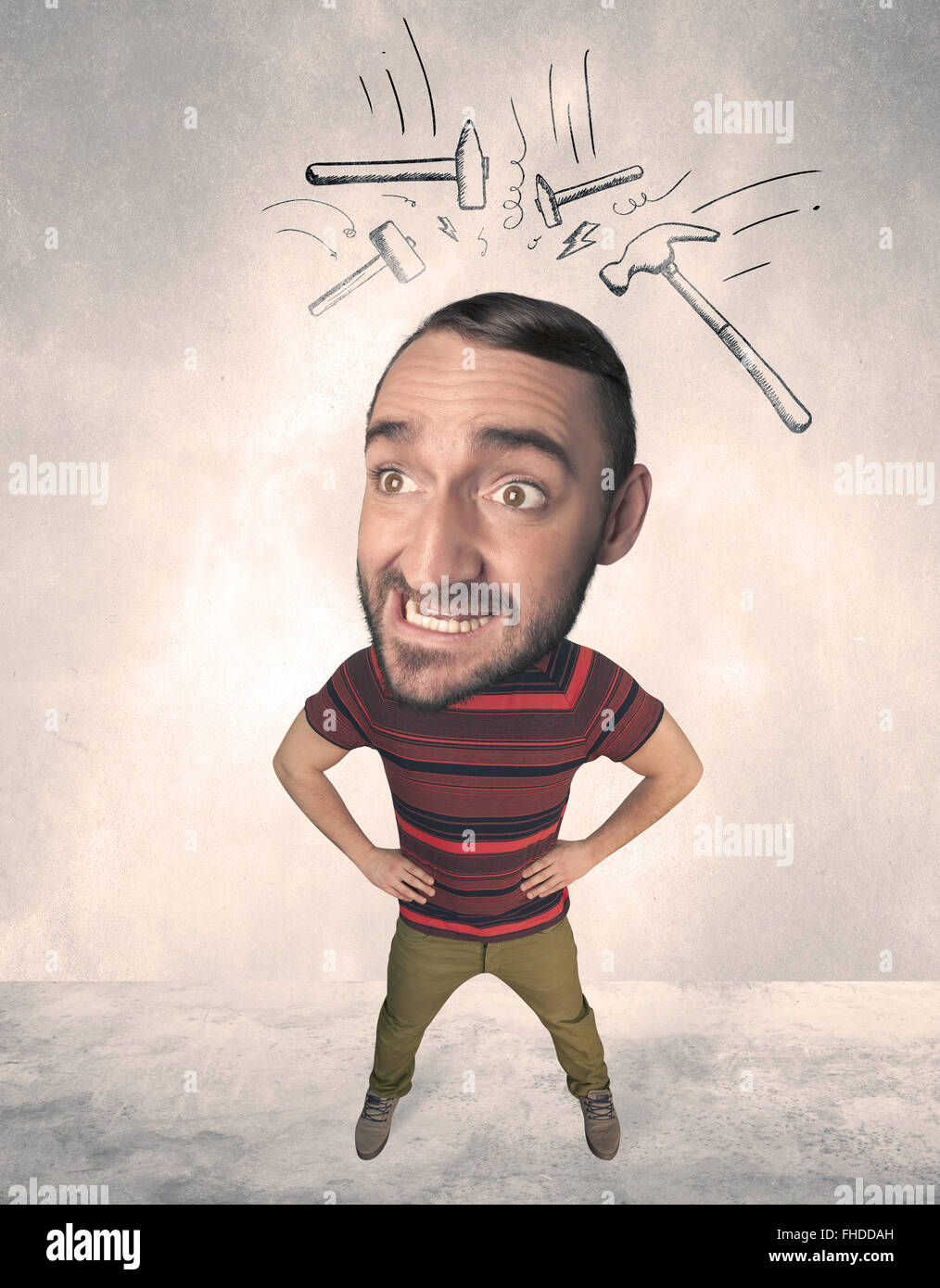 Big head person with drawn hammers Stock Photo - Alamy