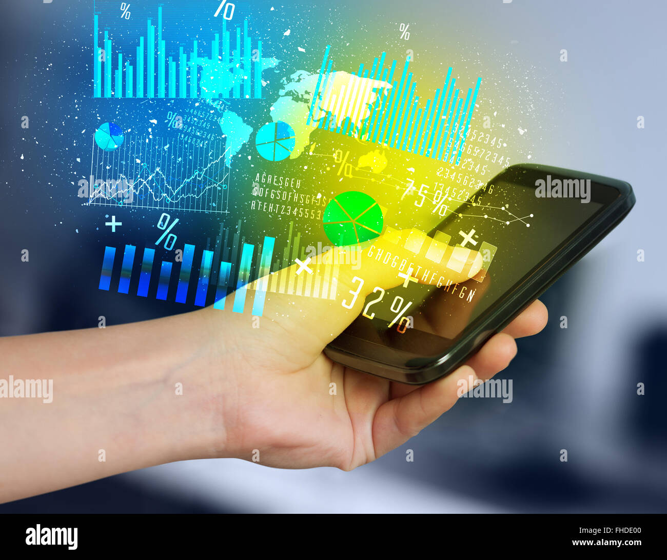Hand holding smartphone with business diagrams Stock Photo - Alamy