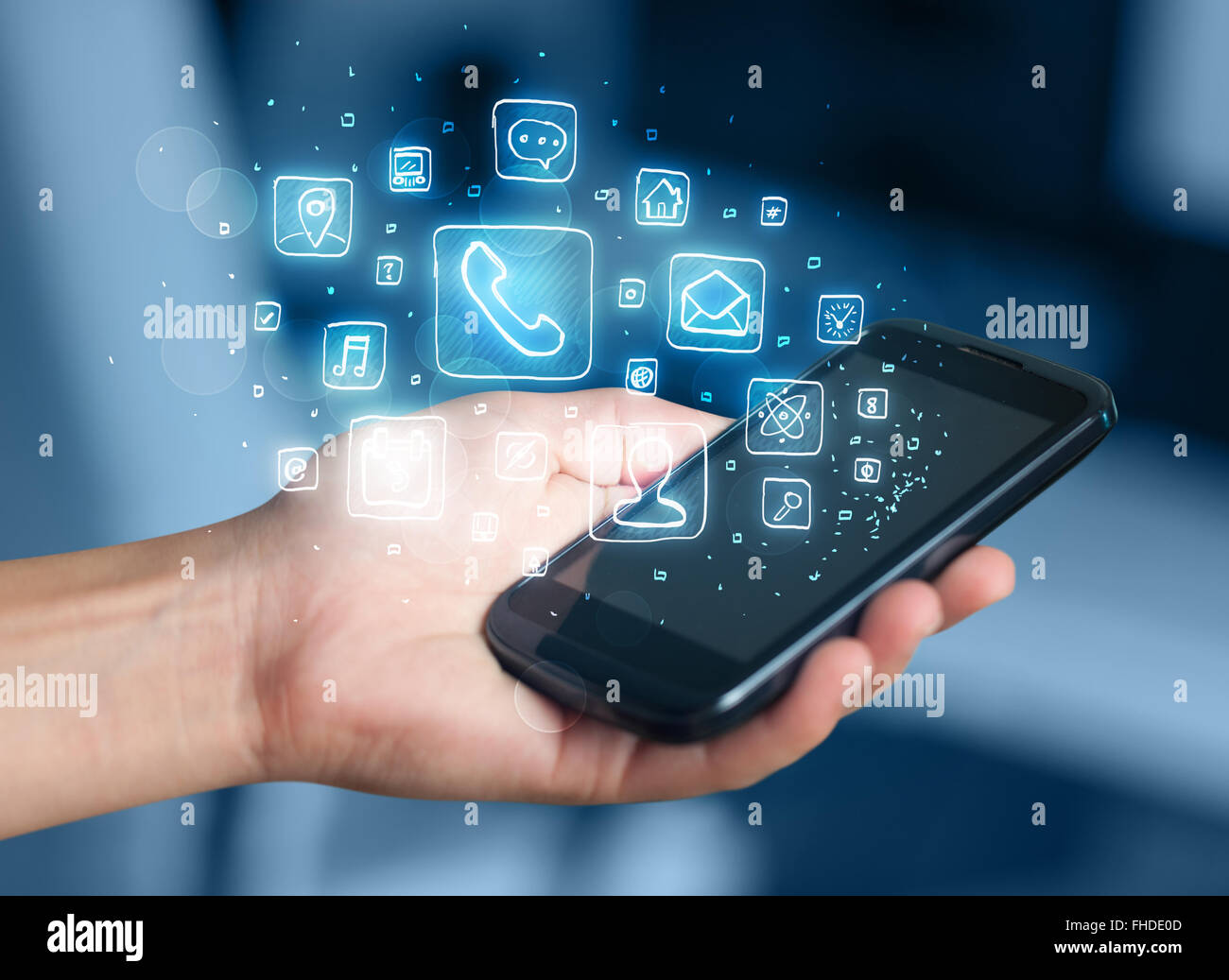Hand holding smartphone with mobile app icons Stock Photo - Alamy