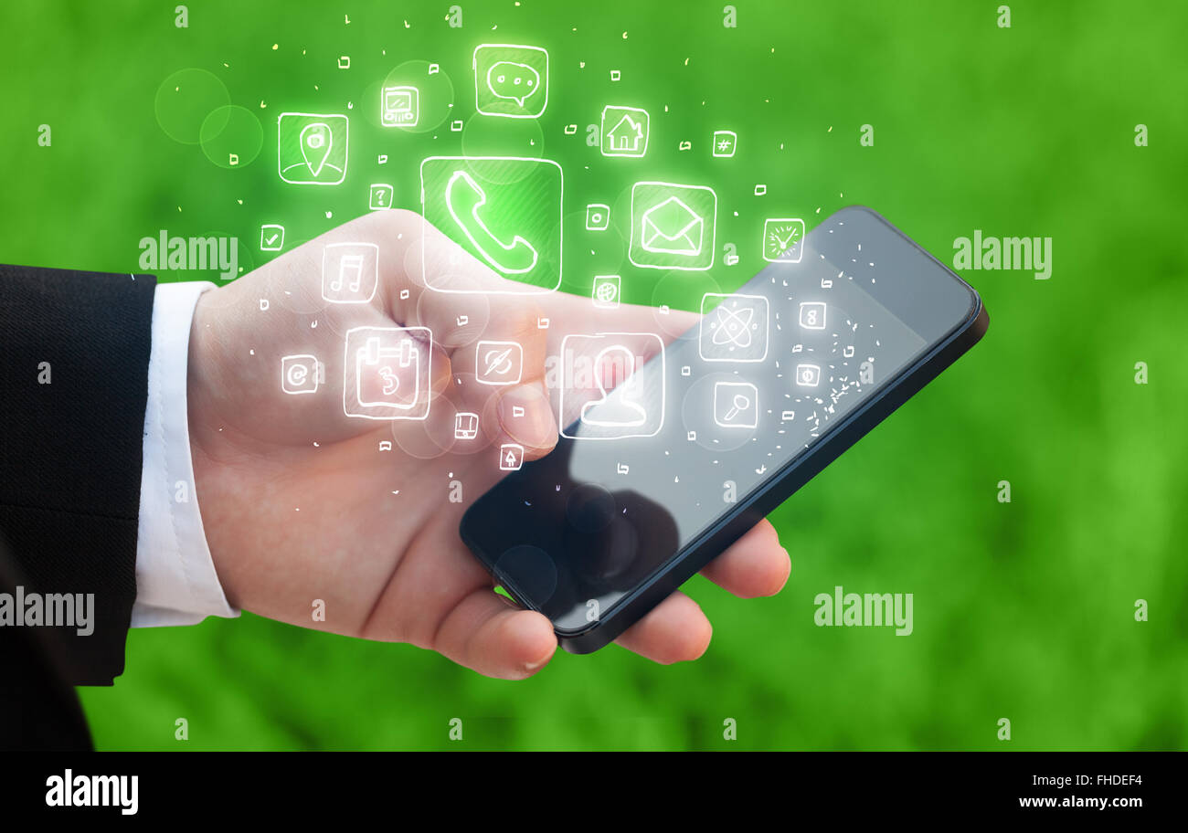 Hand holding smartphone with mobile app icons Stock Photo - Alamy