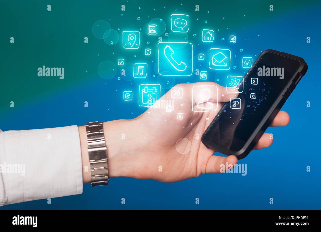 Hand holding smartphone with mobile app icons Stock Photo - Alamy