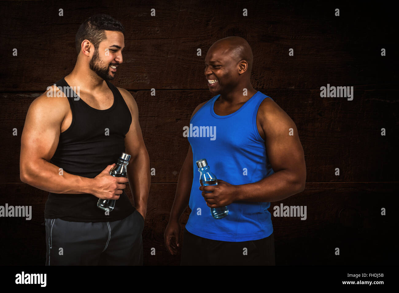 Composite image of strong friends taking a drink Stock Photo - Alamy
