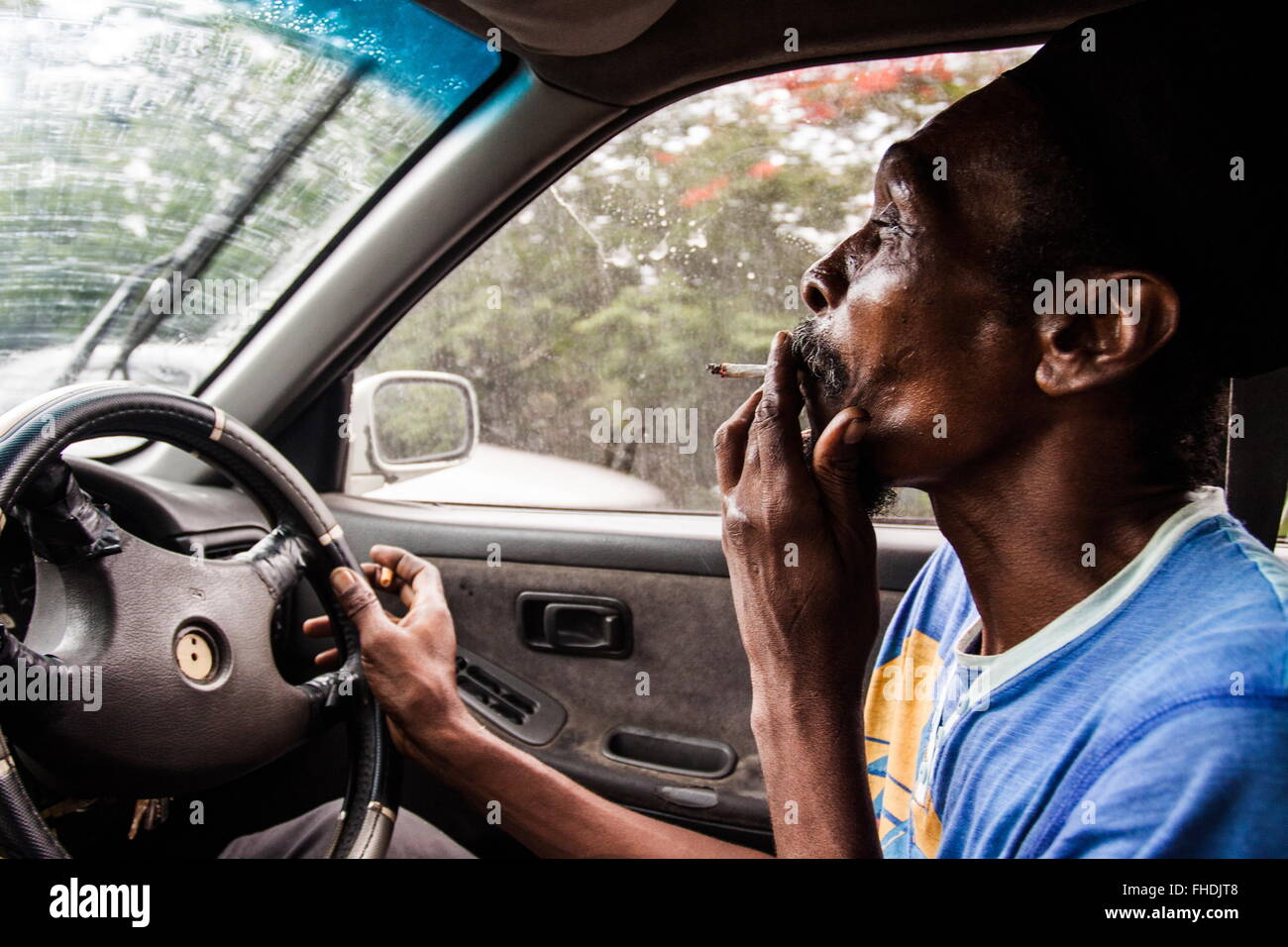 Kingston, Jamaica. 25th May, 2015. Rastaman smokes a marijuana spliff ...